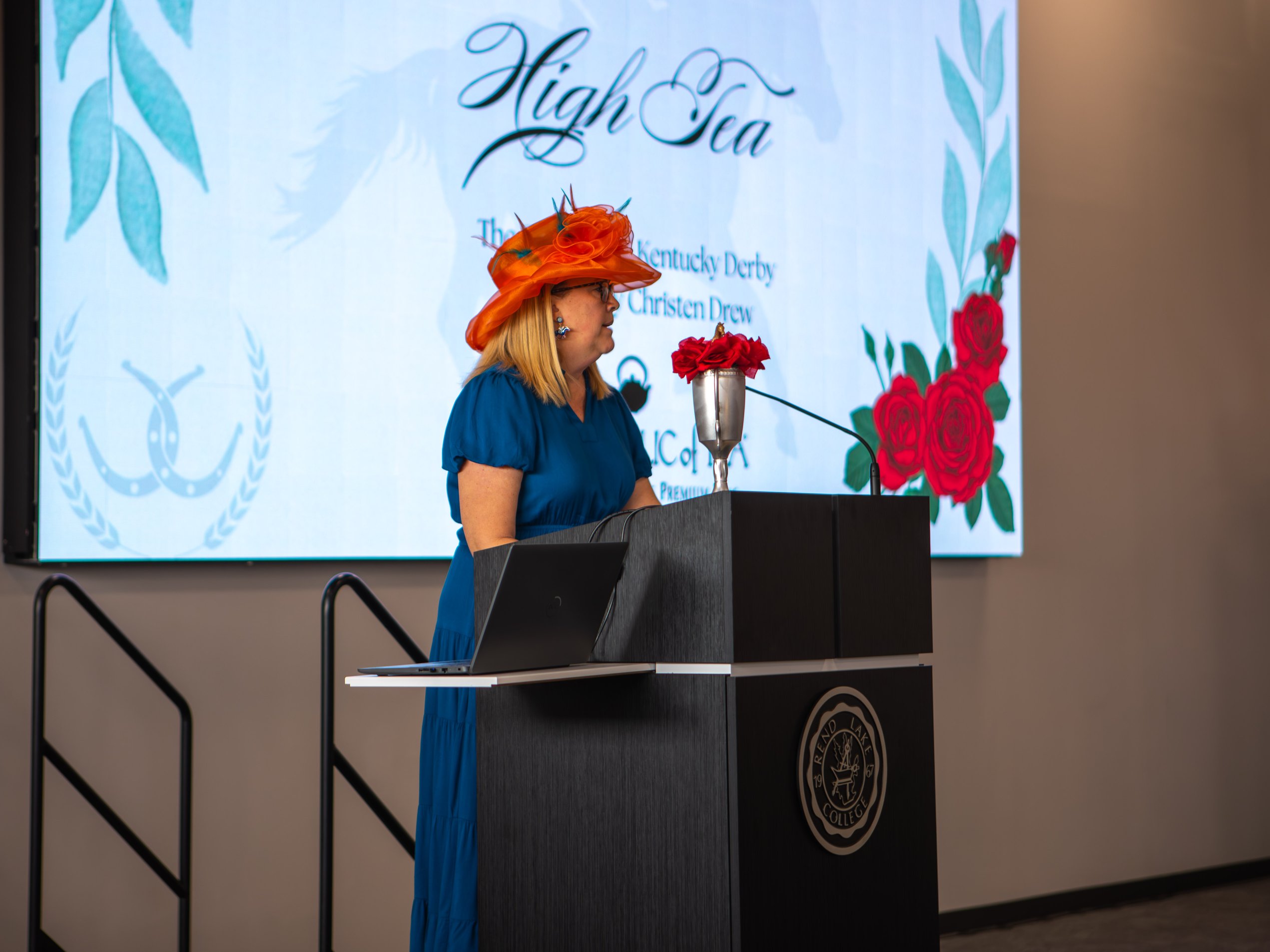 Cathy DeJarnette welcomes the guests to the High Tea.